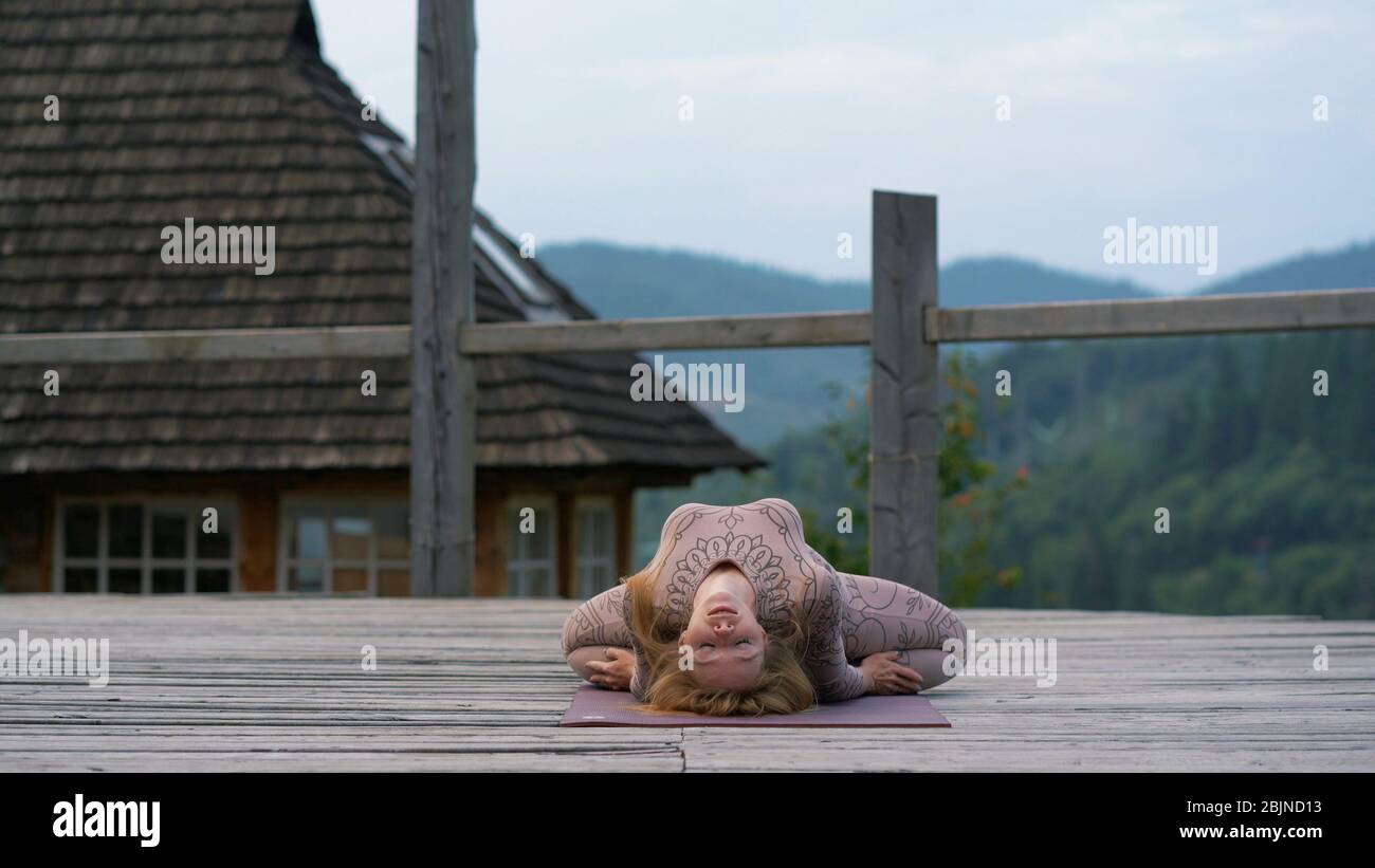 A woman practices yoga at the morning in a terrace on a fresh air Stock ...
