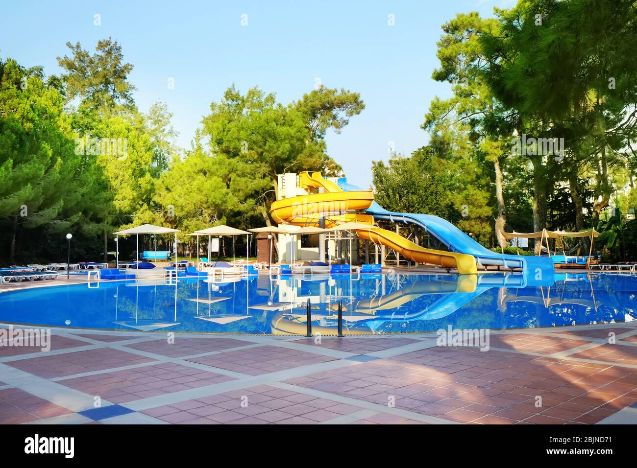 Modern swimming pool with slides outdoors Stock Photo - Alamy