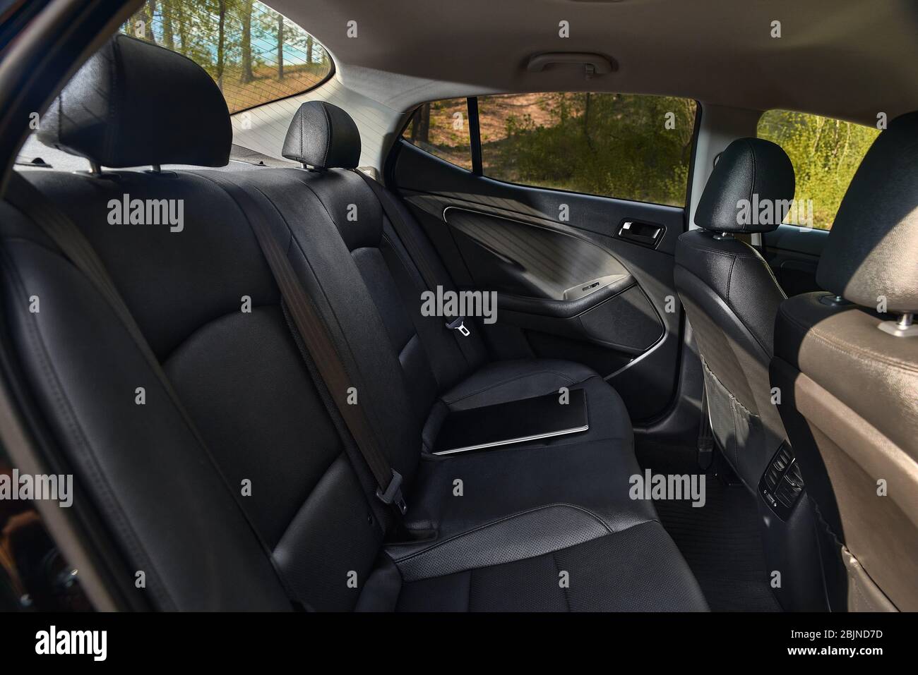 Modern car interior - rear seats with the seat belts Stock Photo - Alamy