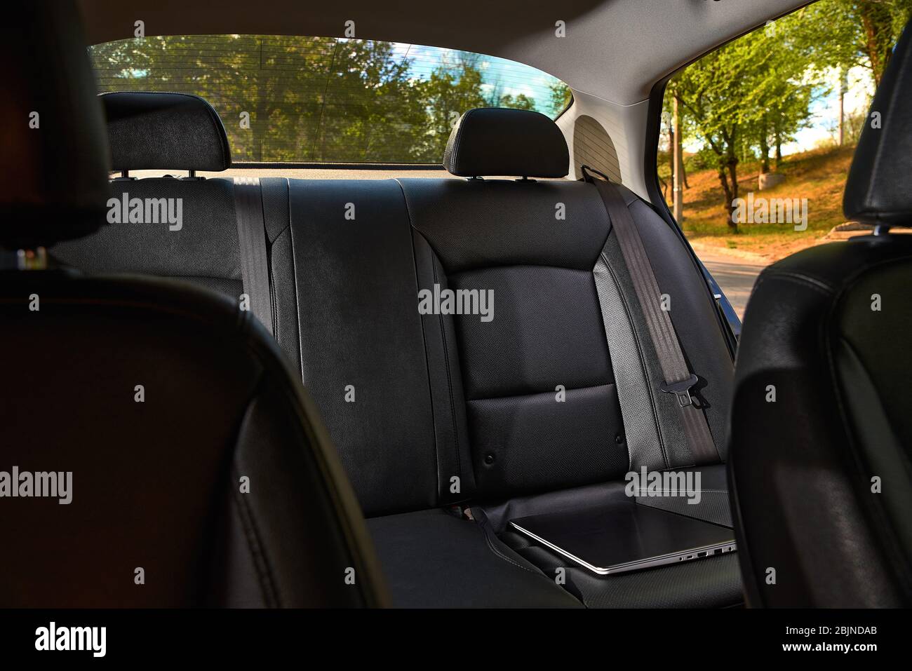 Modern car interior - rear seats with the seat belts Stock Photo - Alamy