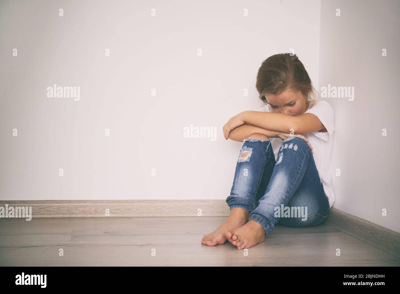 Scared little girl sitting in corner. Domestic violence concept Stock ...