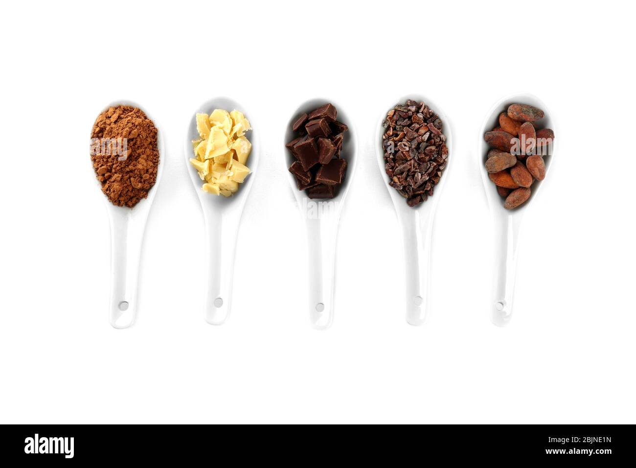 Spoons with different cocoa products on white background Stock Photo ...