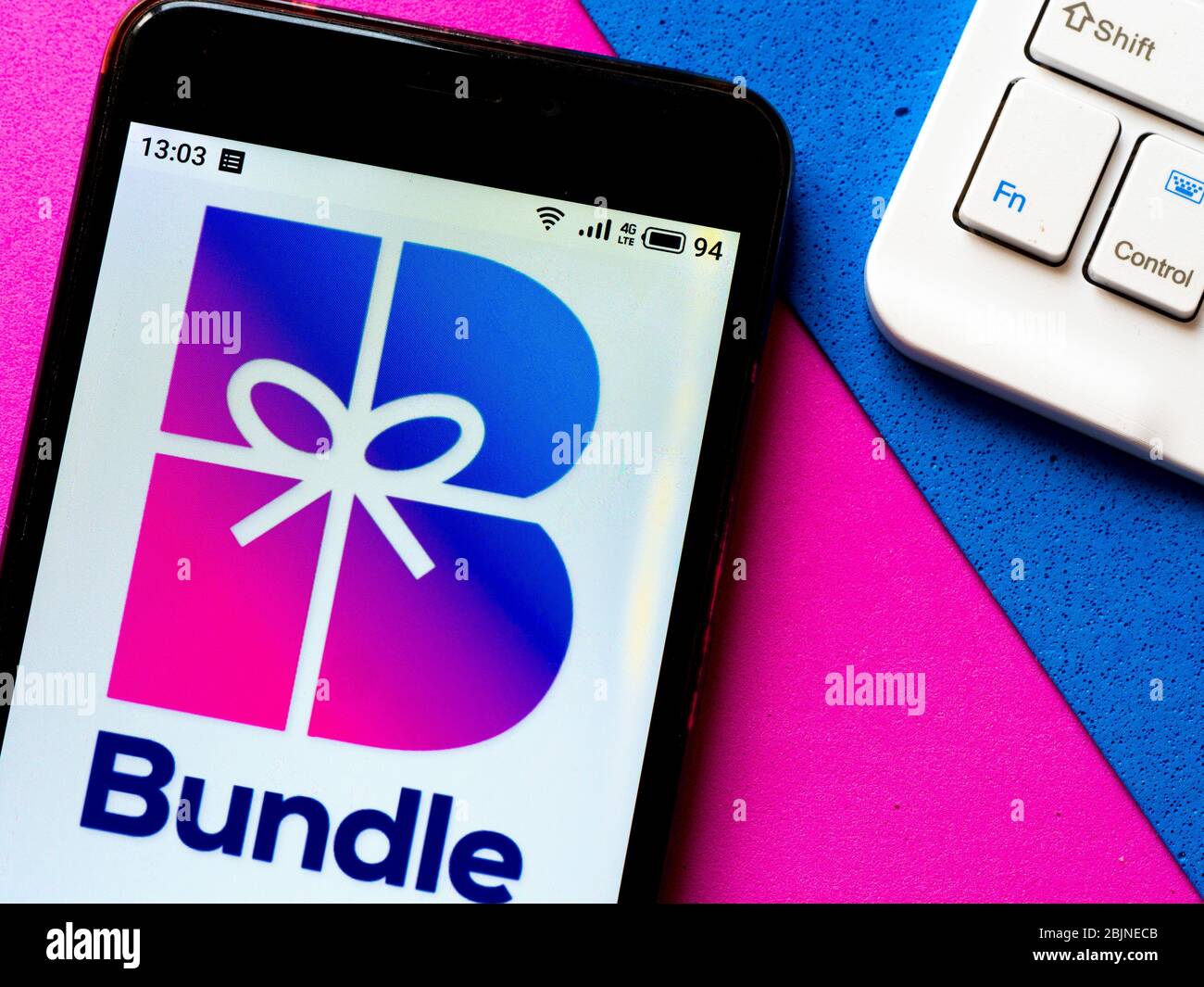 In this photo illustration e-commerce Bundle logo is seen displayed on a smartphone Stock Photo ...