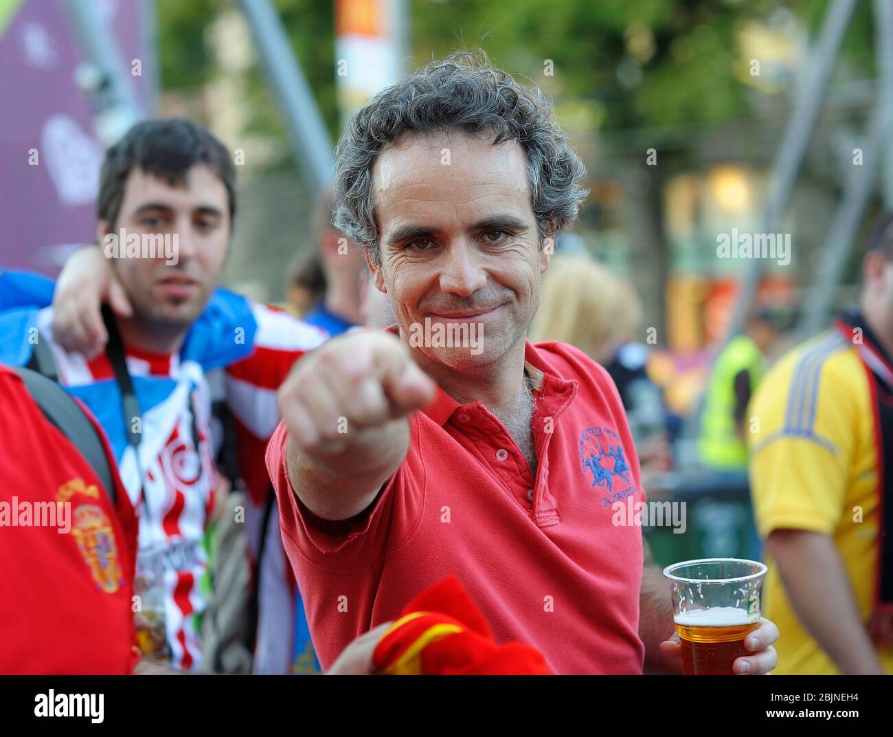Soccer Spanish fan wearing red T-shirt, face painted in national colors ...
