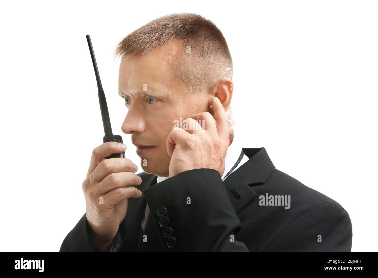 Male security guard using portable radio transmitter on white background Stock Photo - Alamy