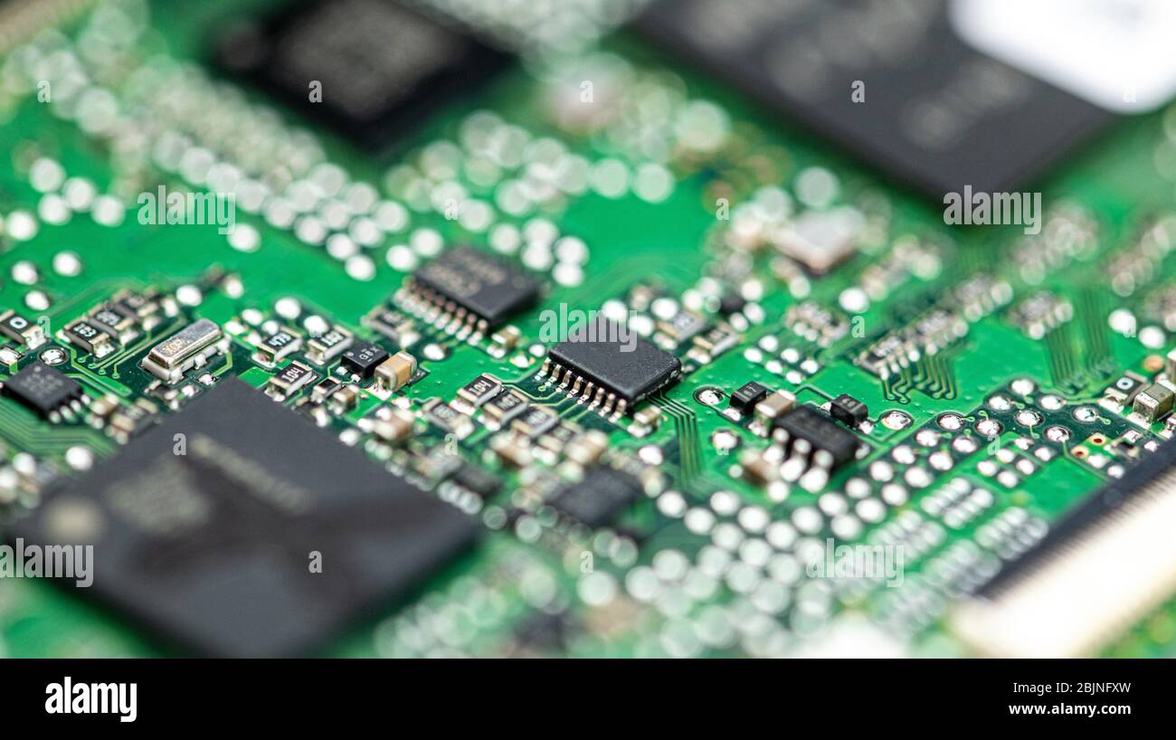Green PCB (printed circuit board) close-up shot with a lot of ...