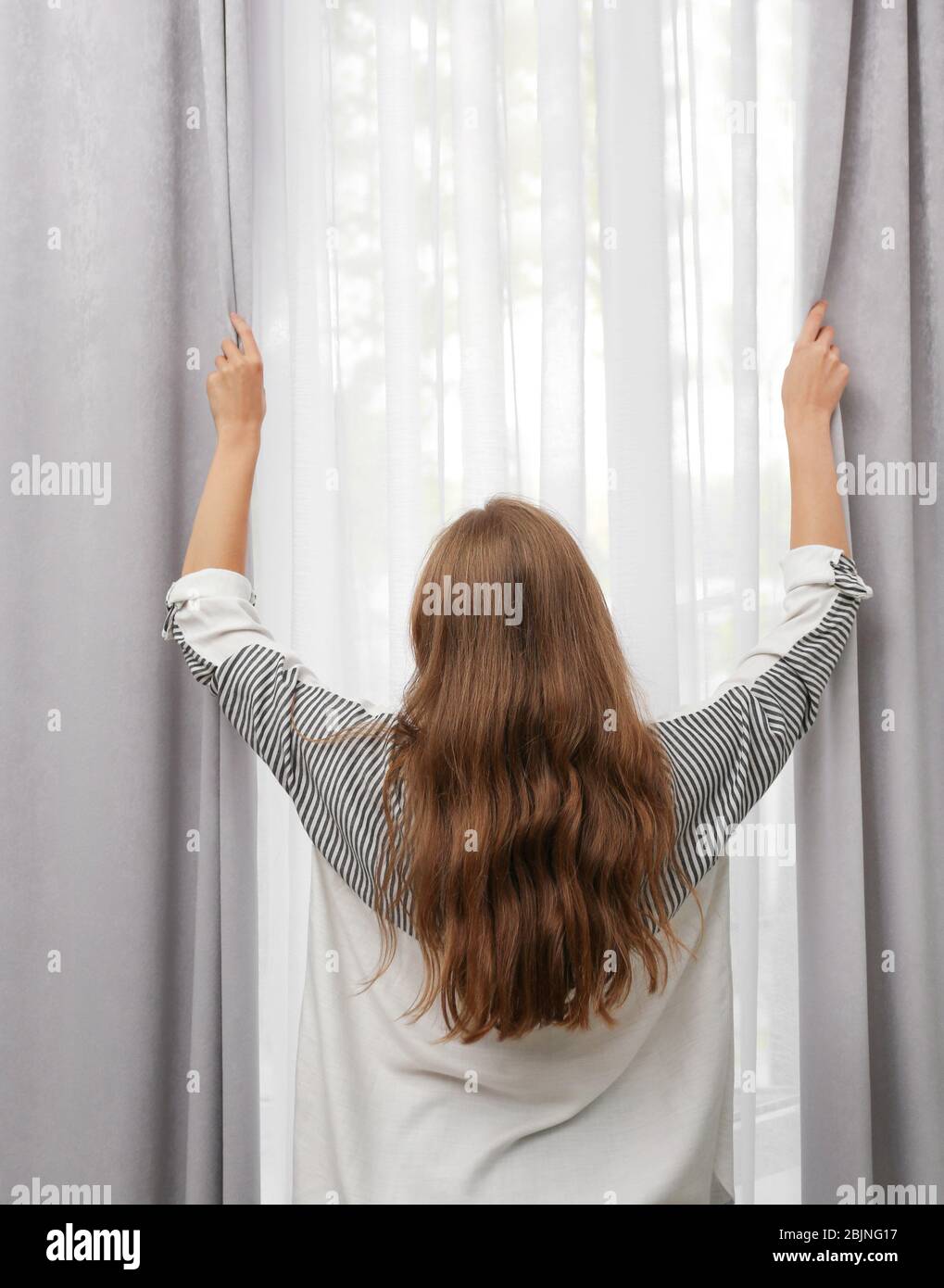 Woman opening stylish curtains hi-res stock photography and images - Alamy