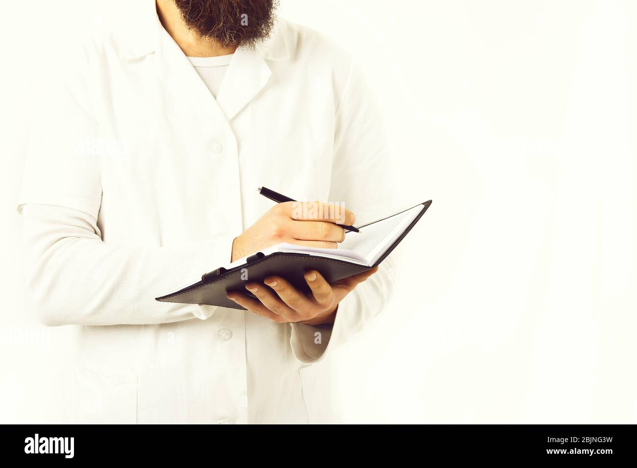 Male hands of caucasian doctor or postgraduate student holding notebook ...