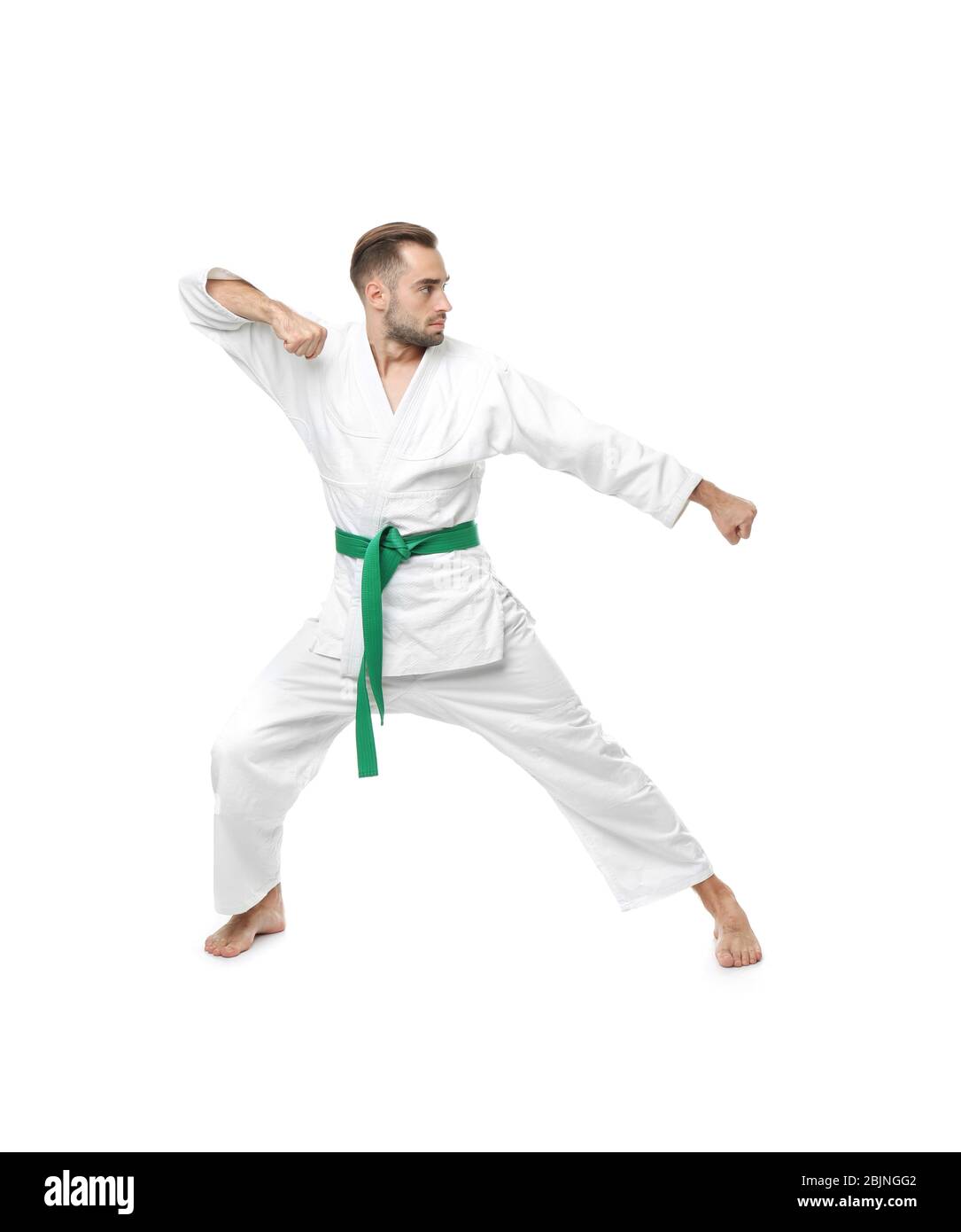 Young man practicing karate on white background Stock Photo - Alamy