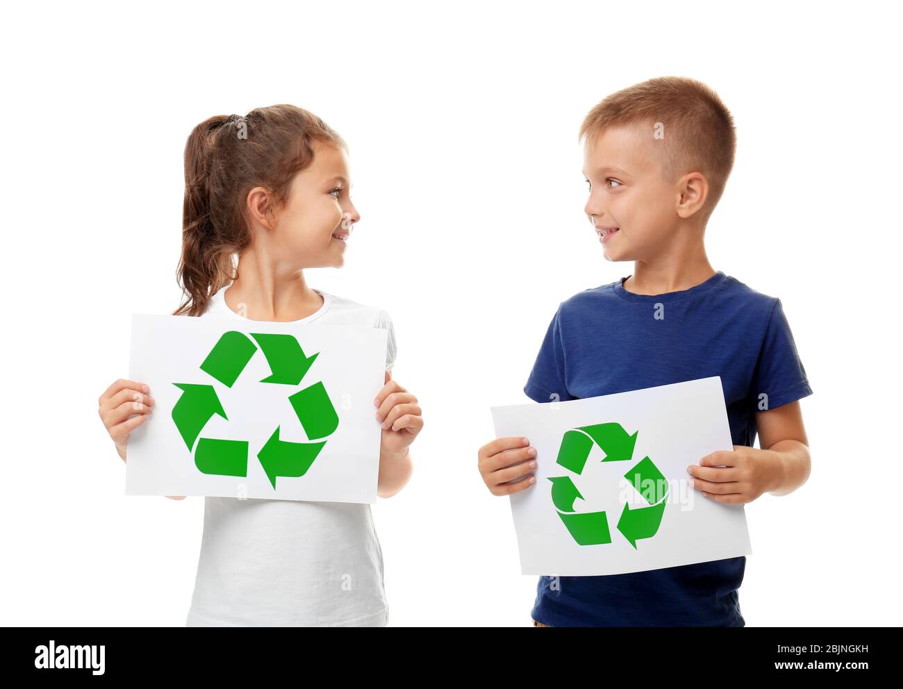 Little children holding paper sheets with recycling symbol on white ...