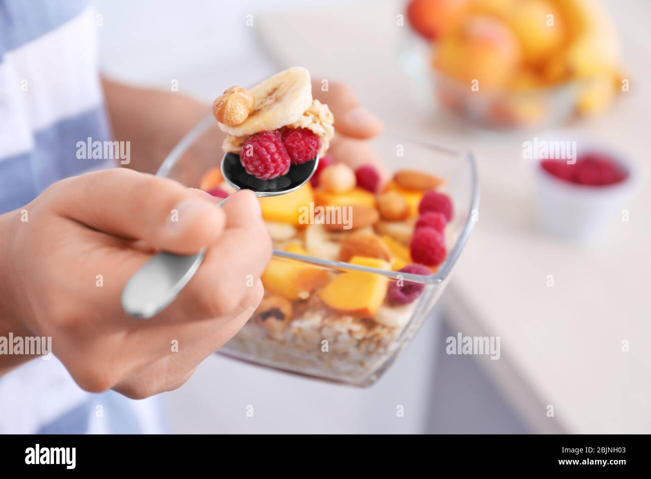Woman eating oatmeal fruits hi-res stock photography and images - Alamy