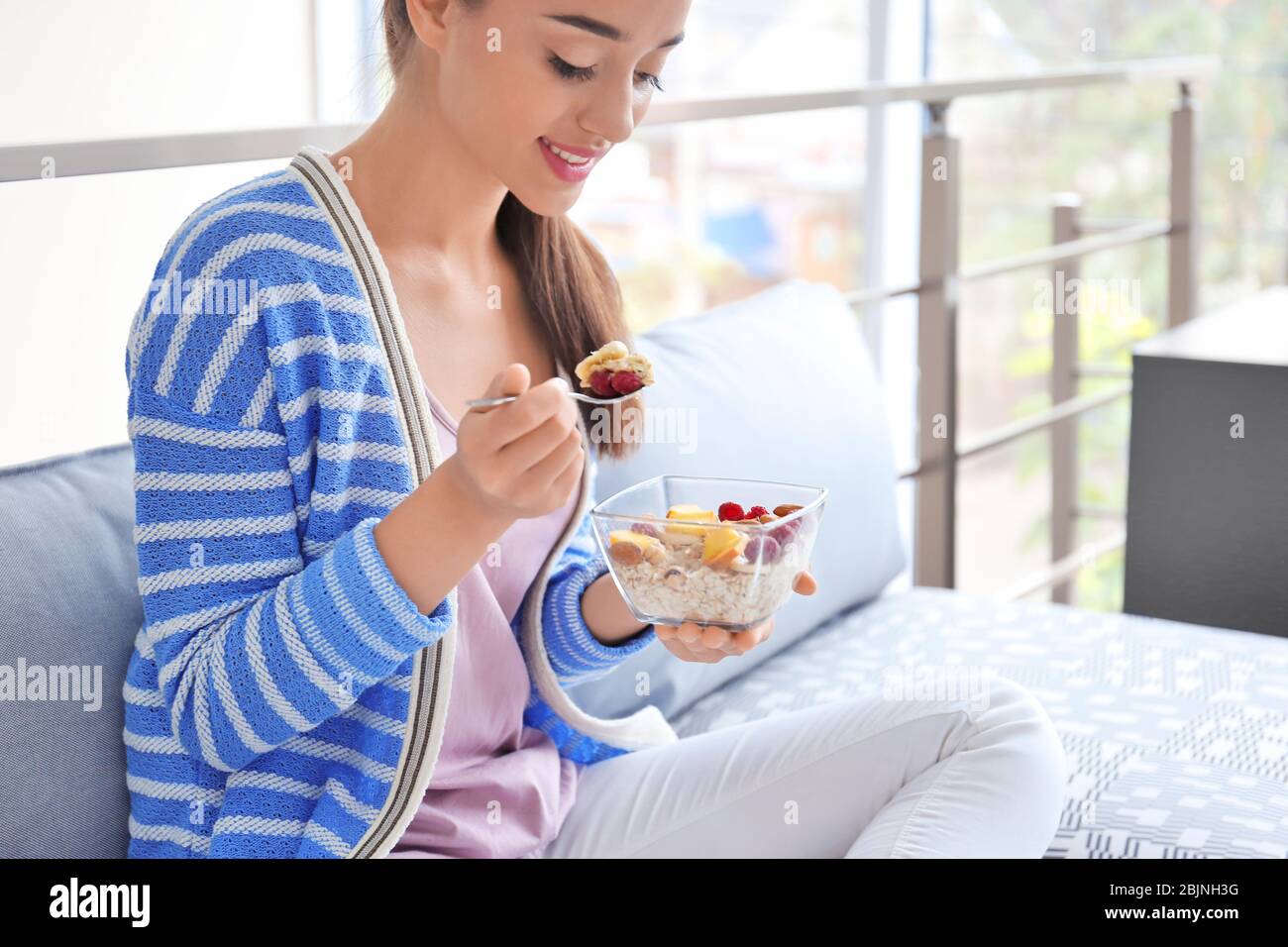 Woman eating oatmeal fruits hi-res stock photography and images - Alamy