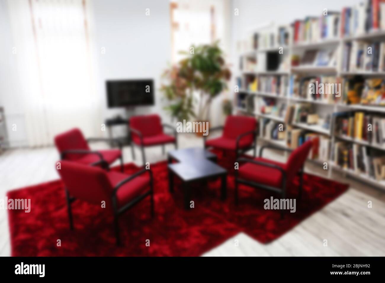 Cozy reading room in library, blurred background Stock Photo - Alamy