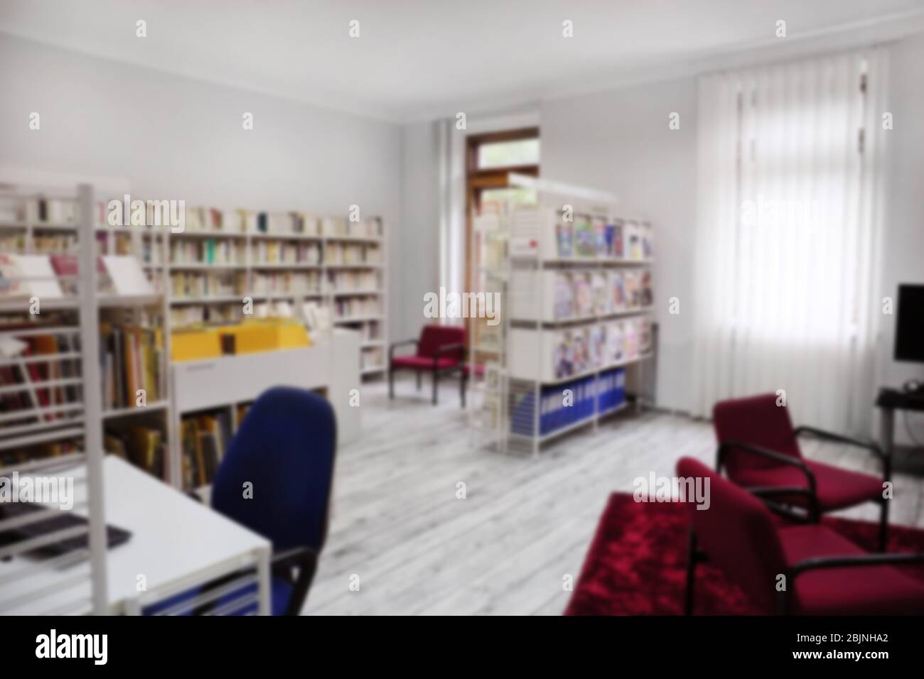 Cozy reading room in library, blurred background Stock Photo - Alamy