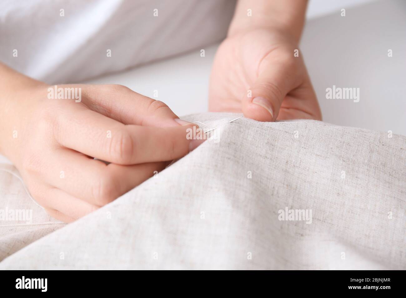 Woman sewing by hand hi-res stock photography and images - Alamy