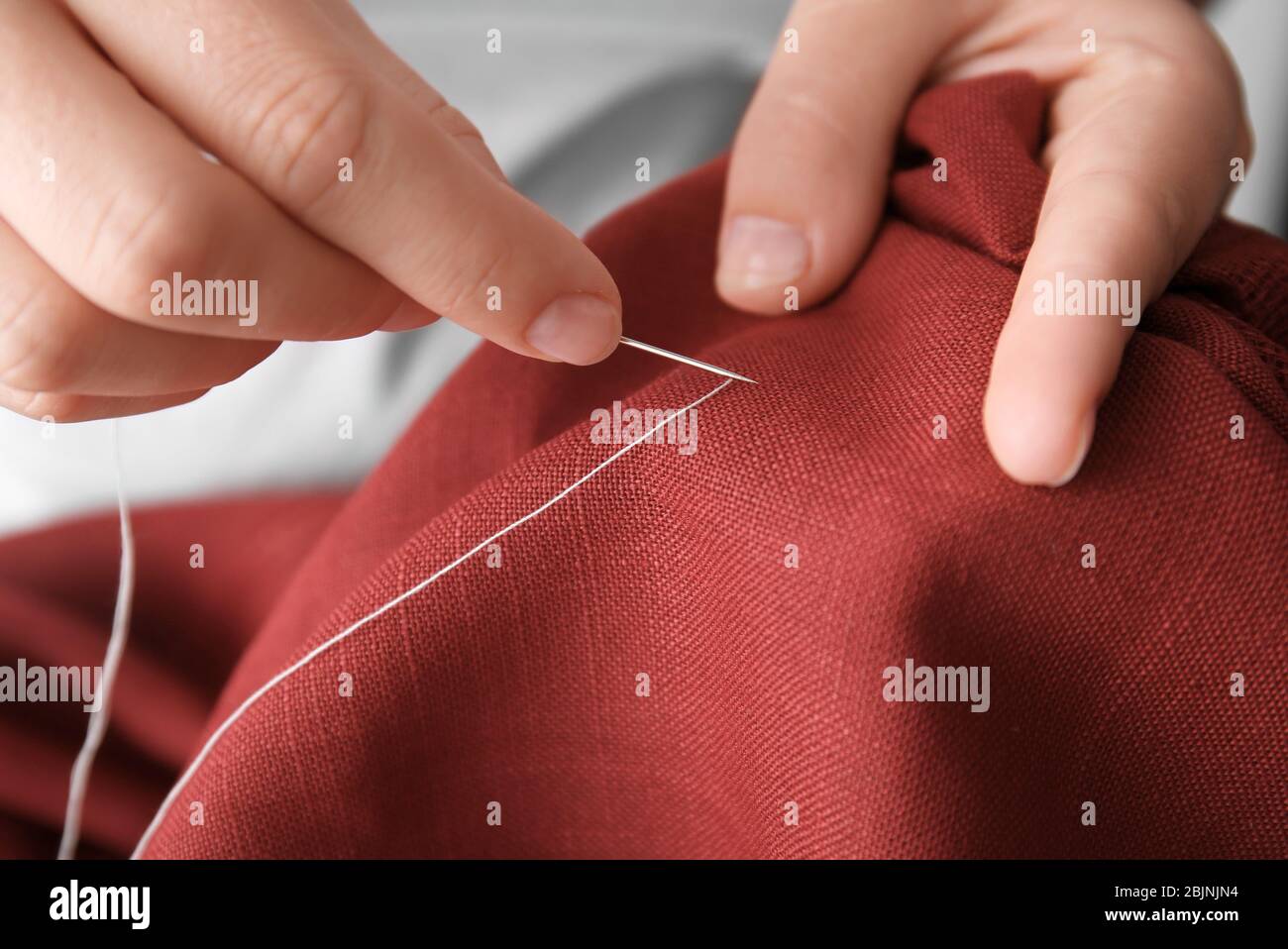 Hands woman seamstress sewing red hi-res stock photography and images ...