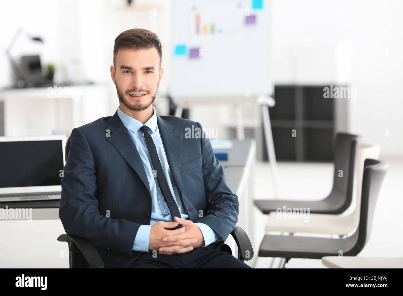 Young handsome man in office Stock Photo - Alamy