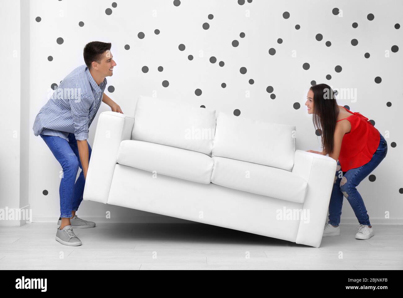 Young couple carrying couch hi-res stock photography and images - Alamy