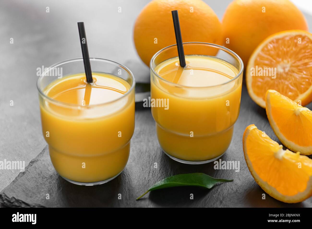 Glasses of fresh orange juice on slate plate Stock Photo - Alamy