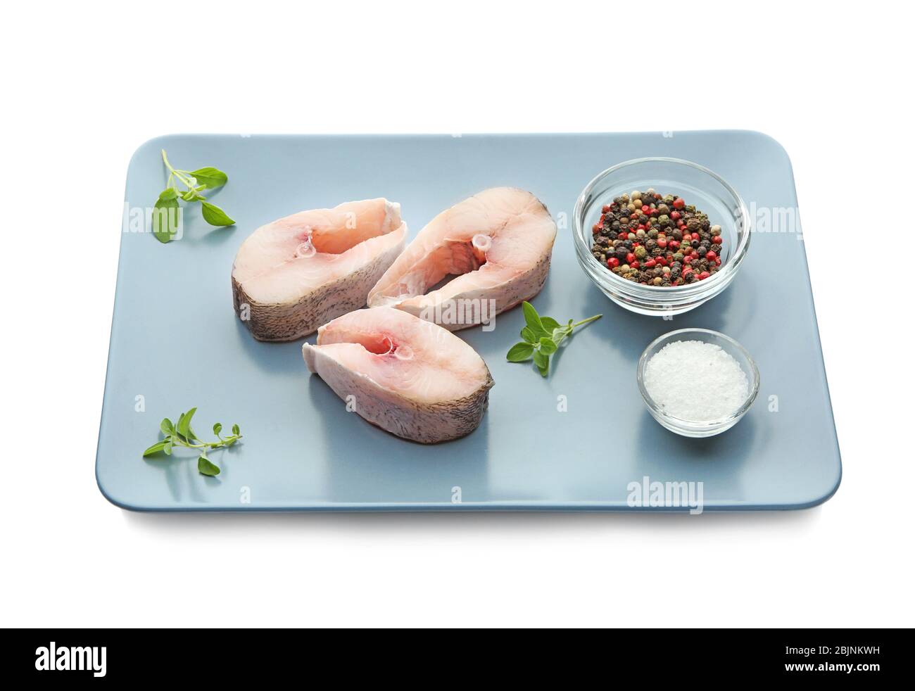 Plate with fresh fish steaks on white background Stock Photo - Alamy