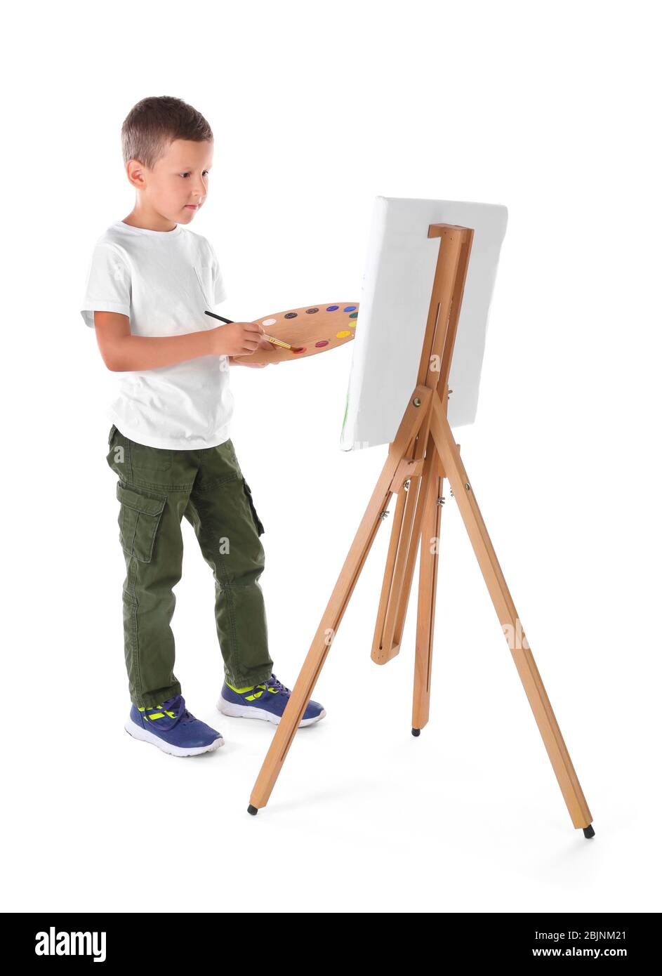 Talented boy painting on canvas against white background Stock Photo ... Talented boy painting on canvas against white background Stock Photo ...