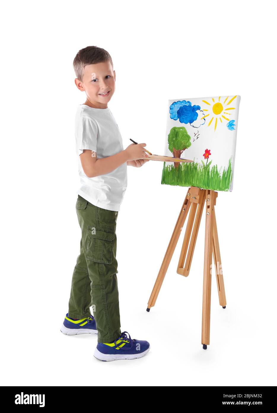 Talented boy painting on canvas against white background Stock Photo ...