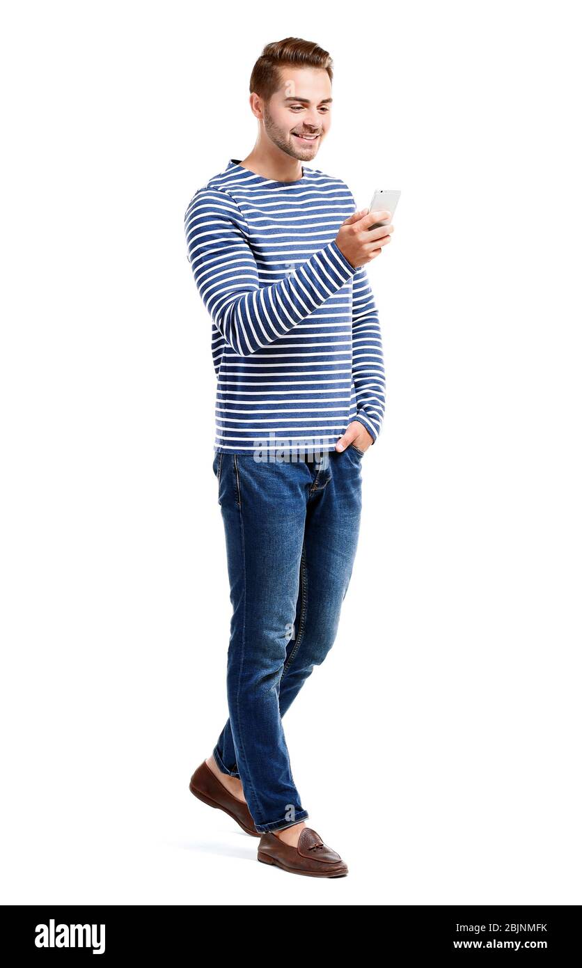 Young handsome man using his mobile phone against white background ...
