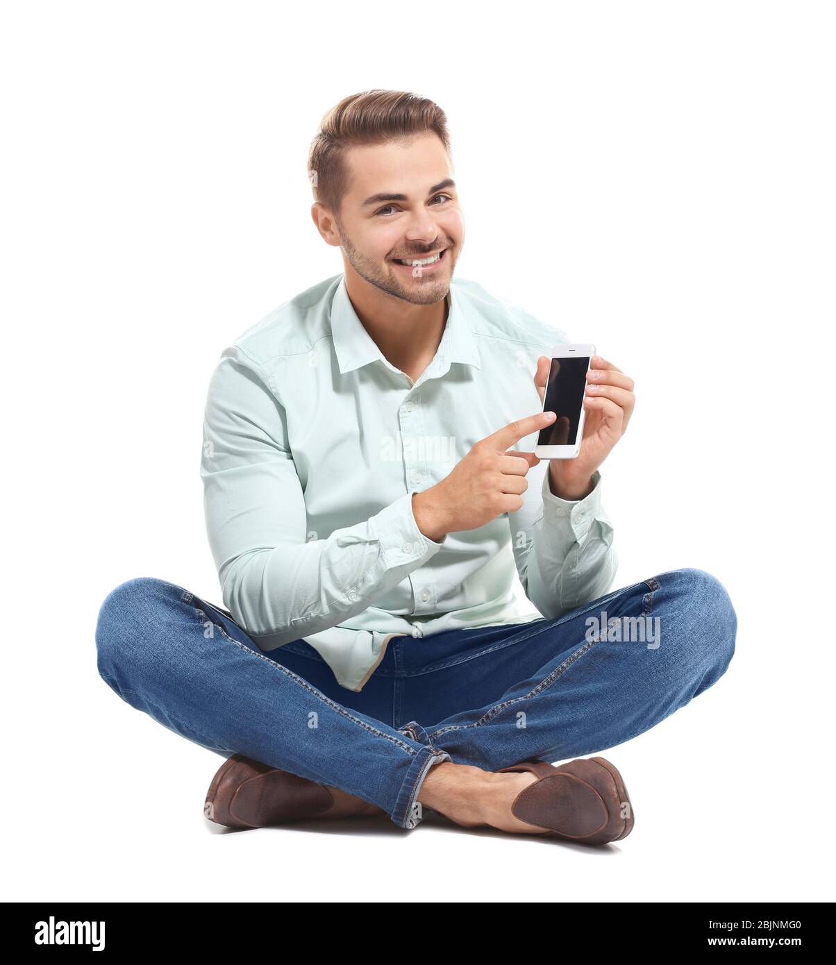 Young handsome man with mobile phone against white background Stock ...