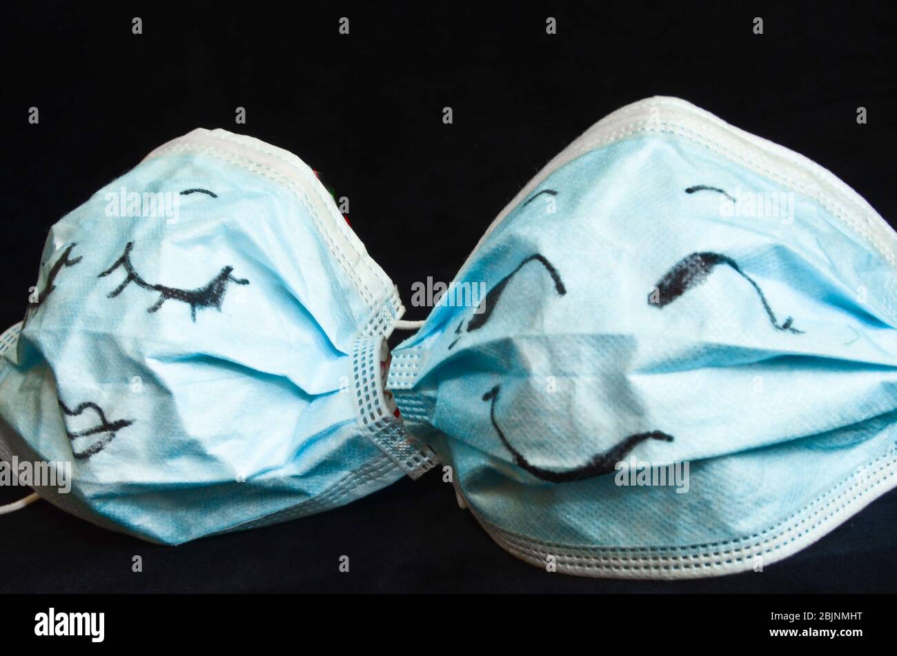 Two funny protection masks against Corona, with faces, like a man and a ...