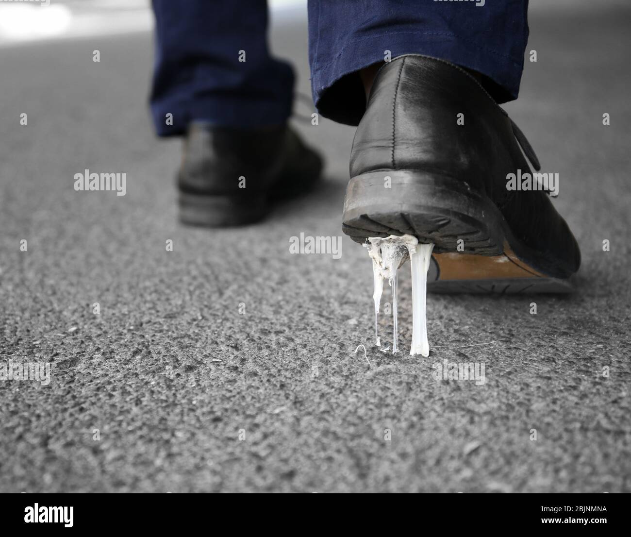 Foot stuck into chewing gum on street. Concept of stickiness Stock ...