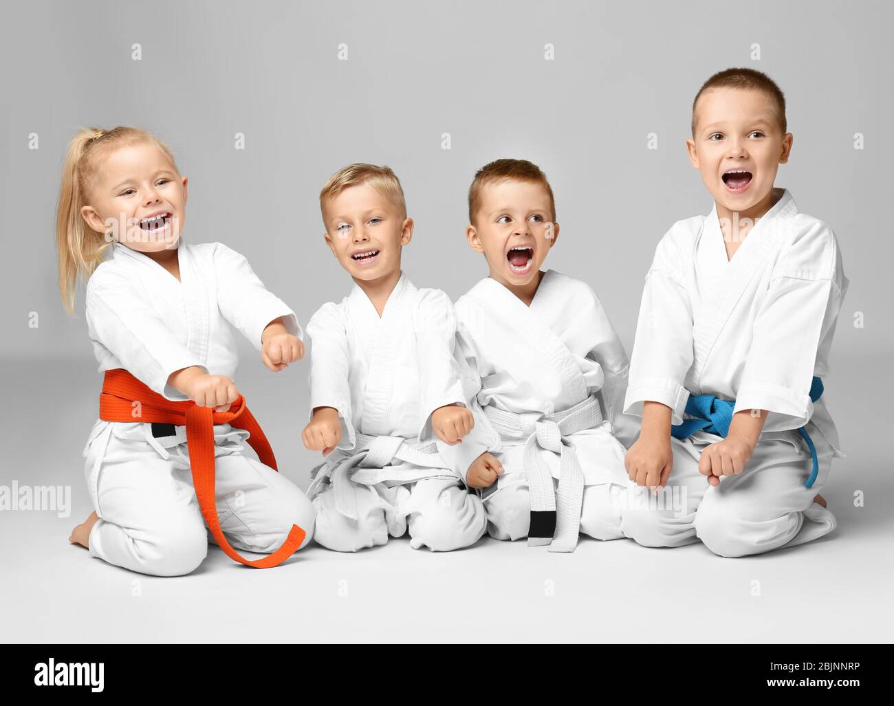 Little children in karategi on light background Stock Photo - Alamy