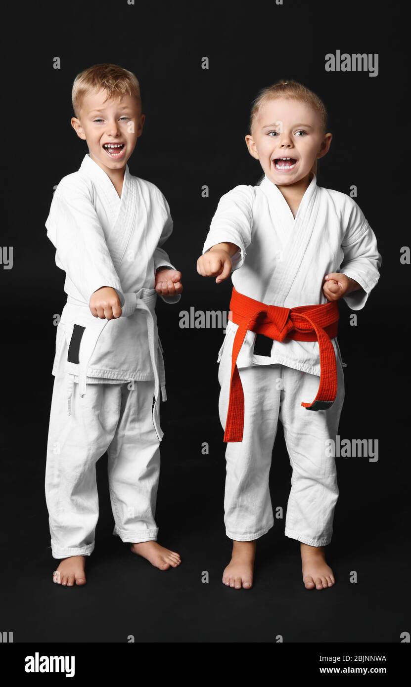 Little children practicing karate on dark background Stock Photo - Alamy