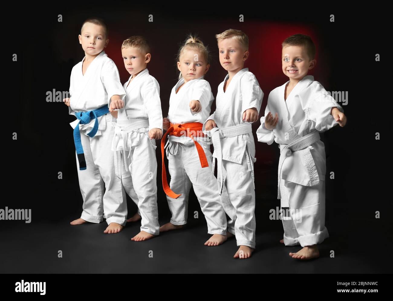 Little children practicing karate on dark background Stock Photo - Alamy