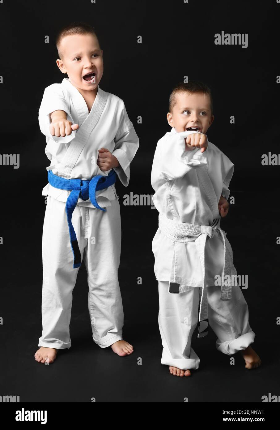 Little children practicing karate on dark background Stock Photo - Alamy