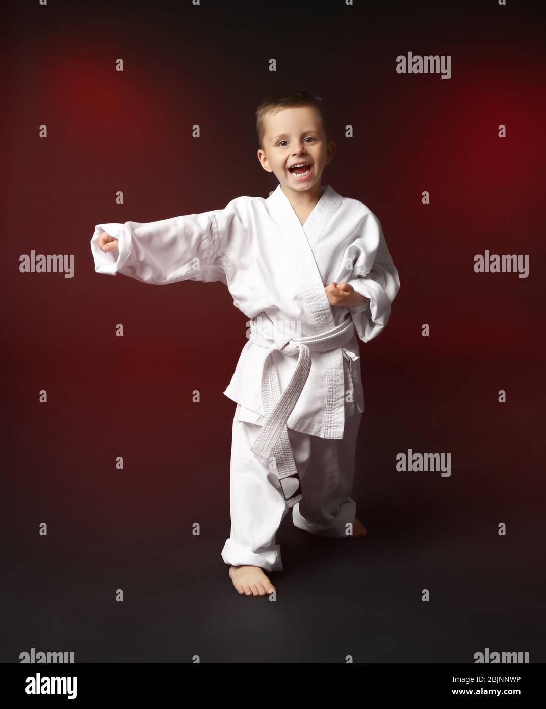 Little boy practicing karate on dark background Stock Photo - Alamy