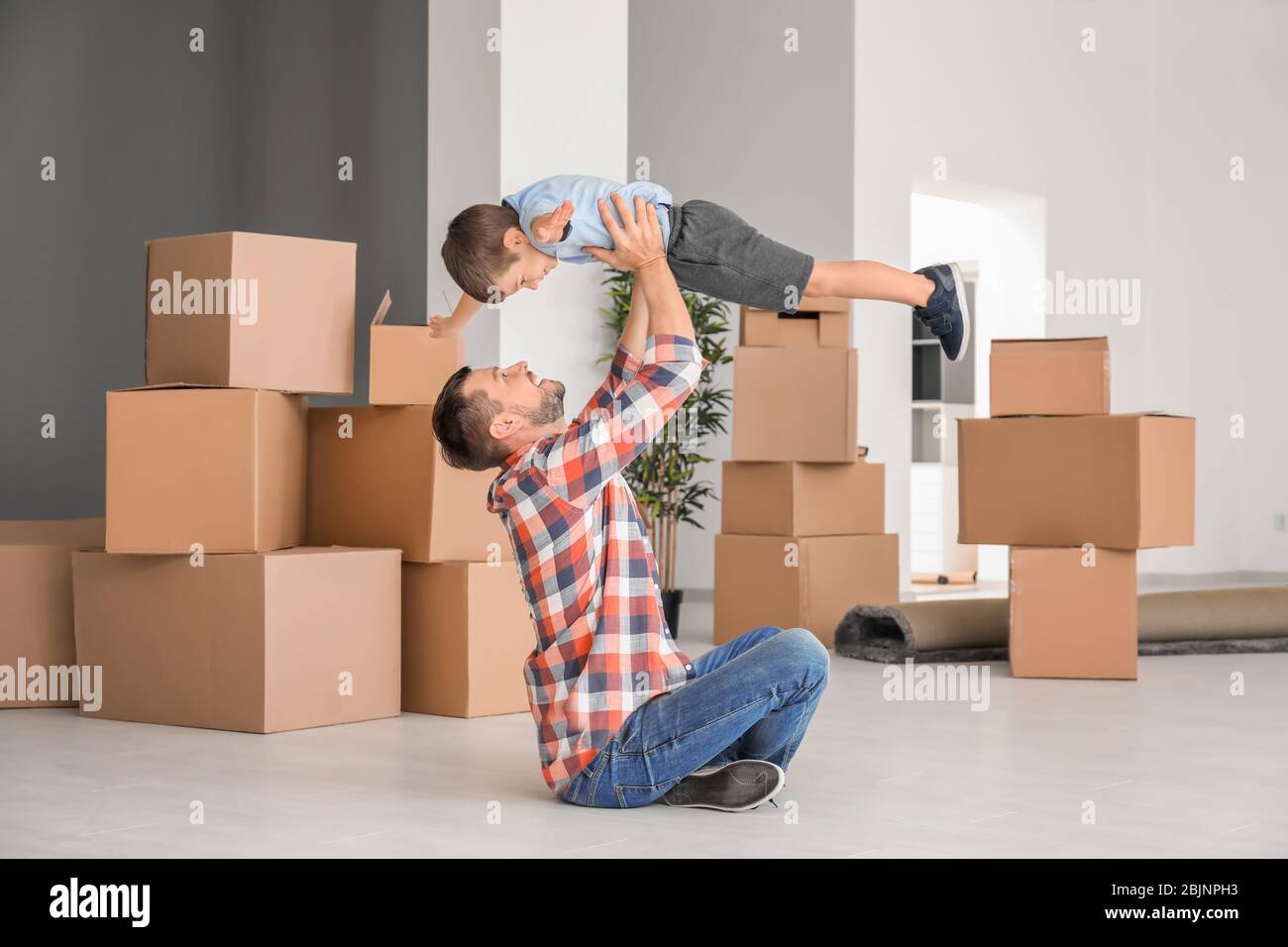 Happy father with child in new flat Stock Photo - Alamy