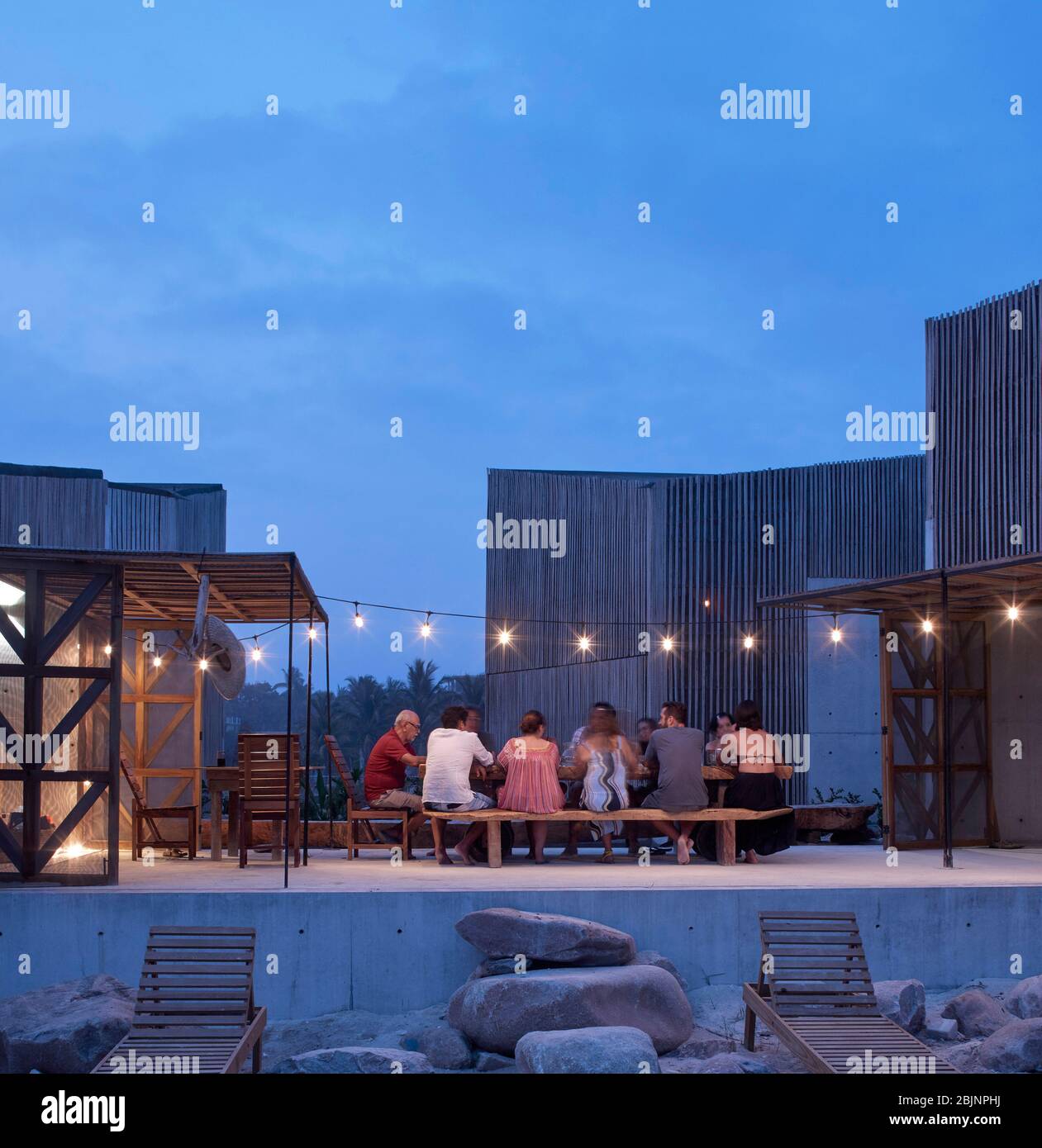 Outside dining at dinner time in communal courtyard. Casa Naila, Puerto ...
