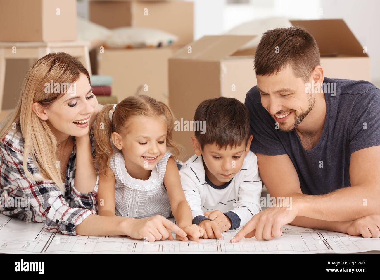 Happy family studying project of new flat Stock Photo - Alamy