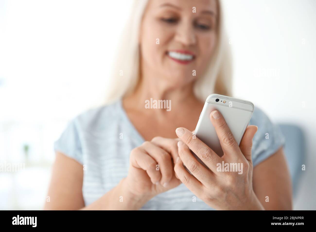 Senior woman using cell hi-res stock photography and images - Alamy