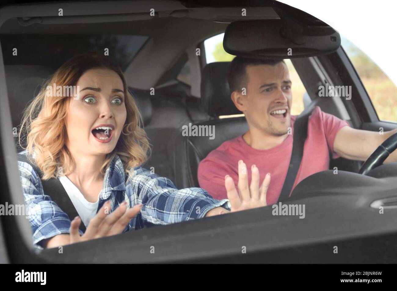 Emotional young couple in car during auto accident Stock Photo - Alamy