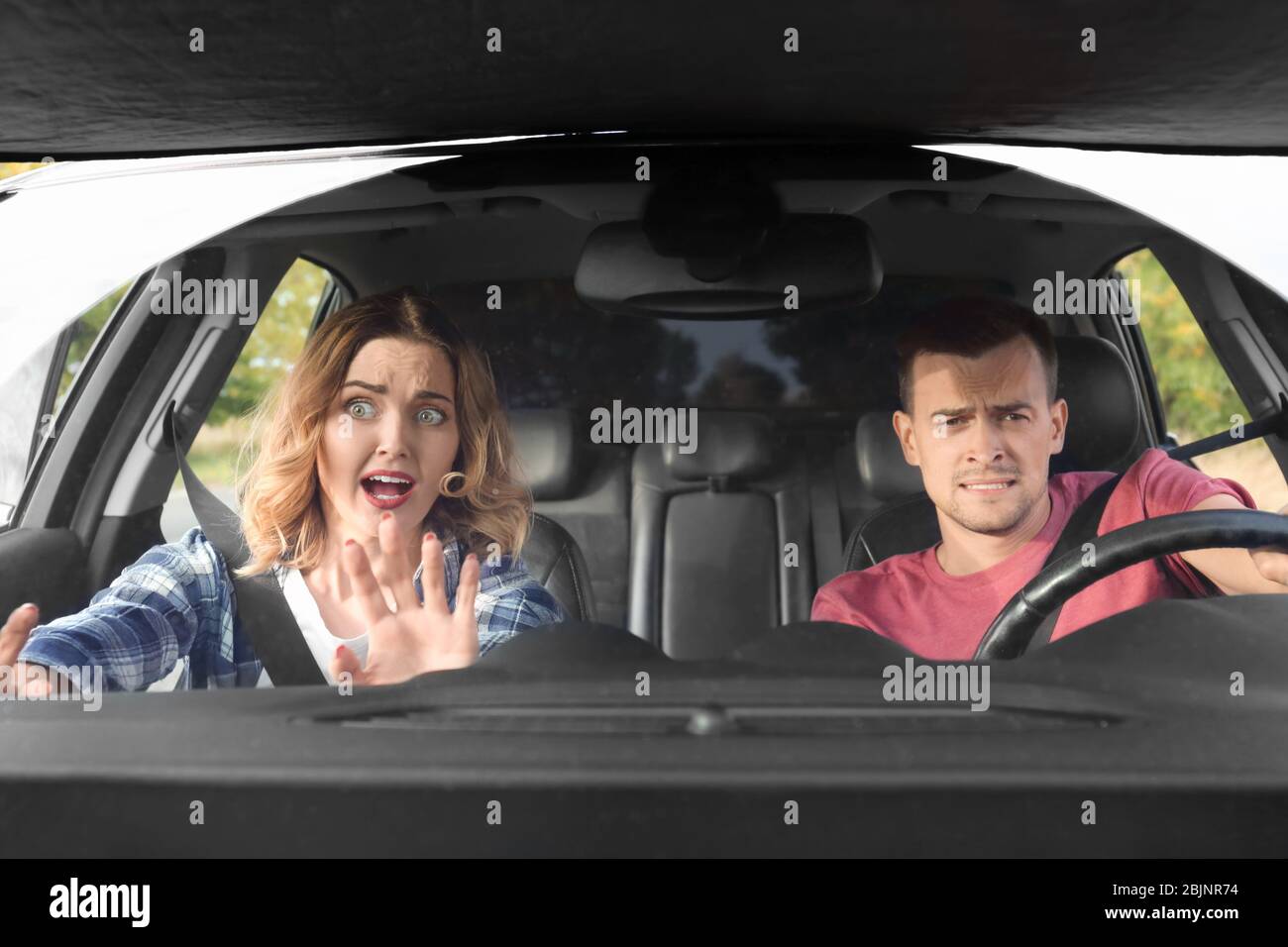 Emotional young couple in car during auto accident Stock Photo - Alamy