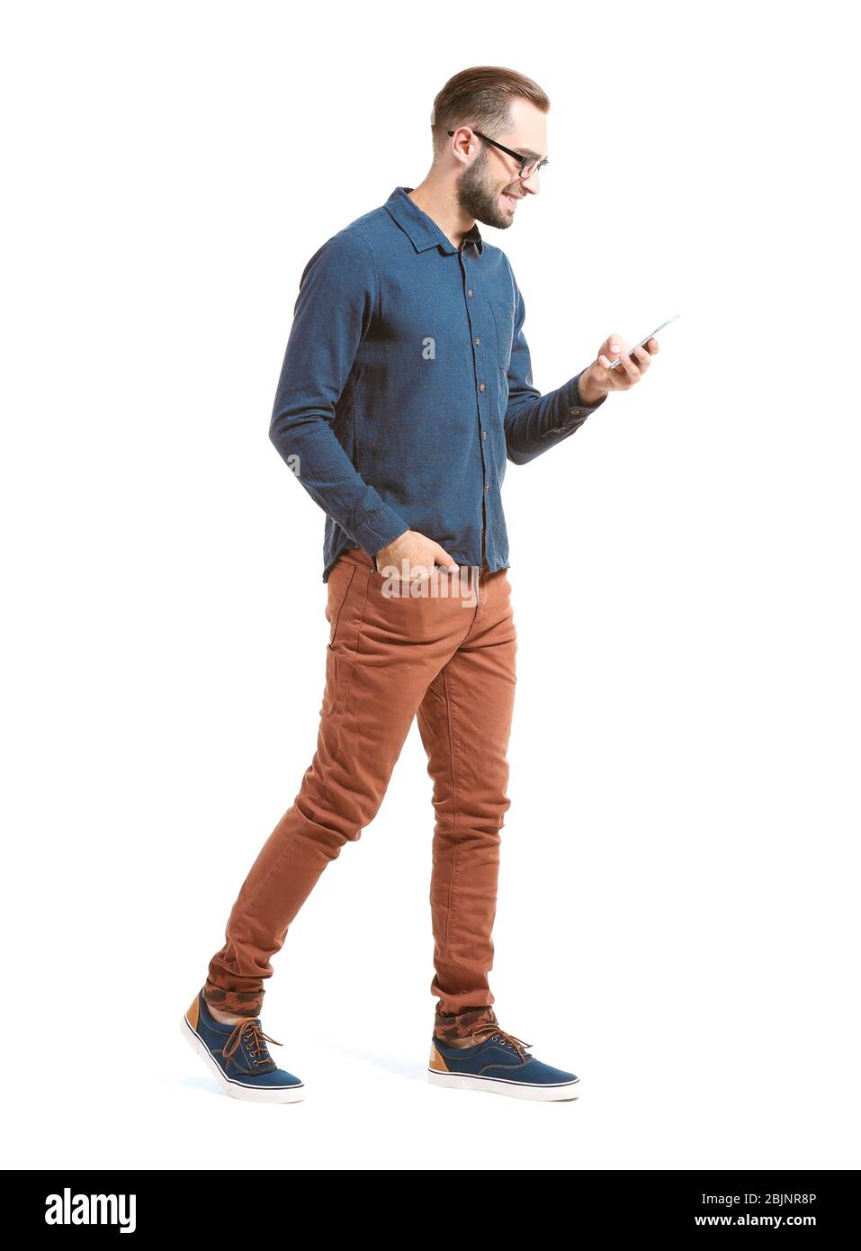 Attractive young man with smartphone on white background Stock Photo ...