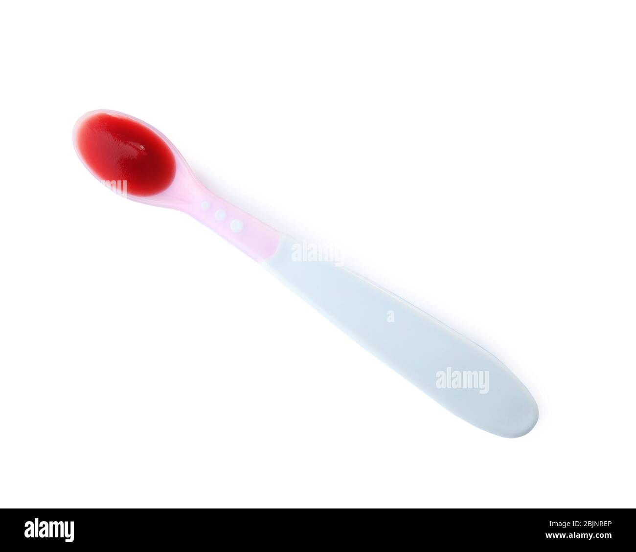 Plastic spoon with baby food on white background Stock Photo - Alamy
