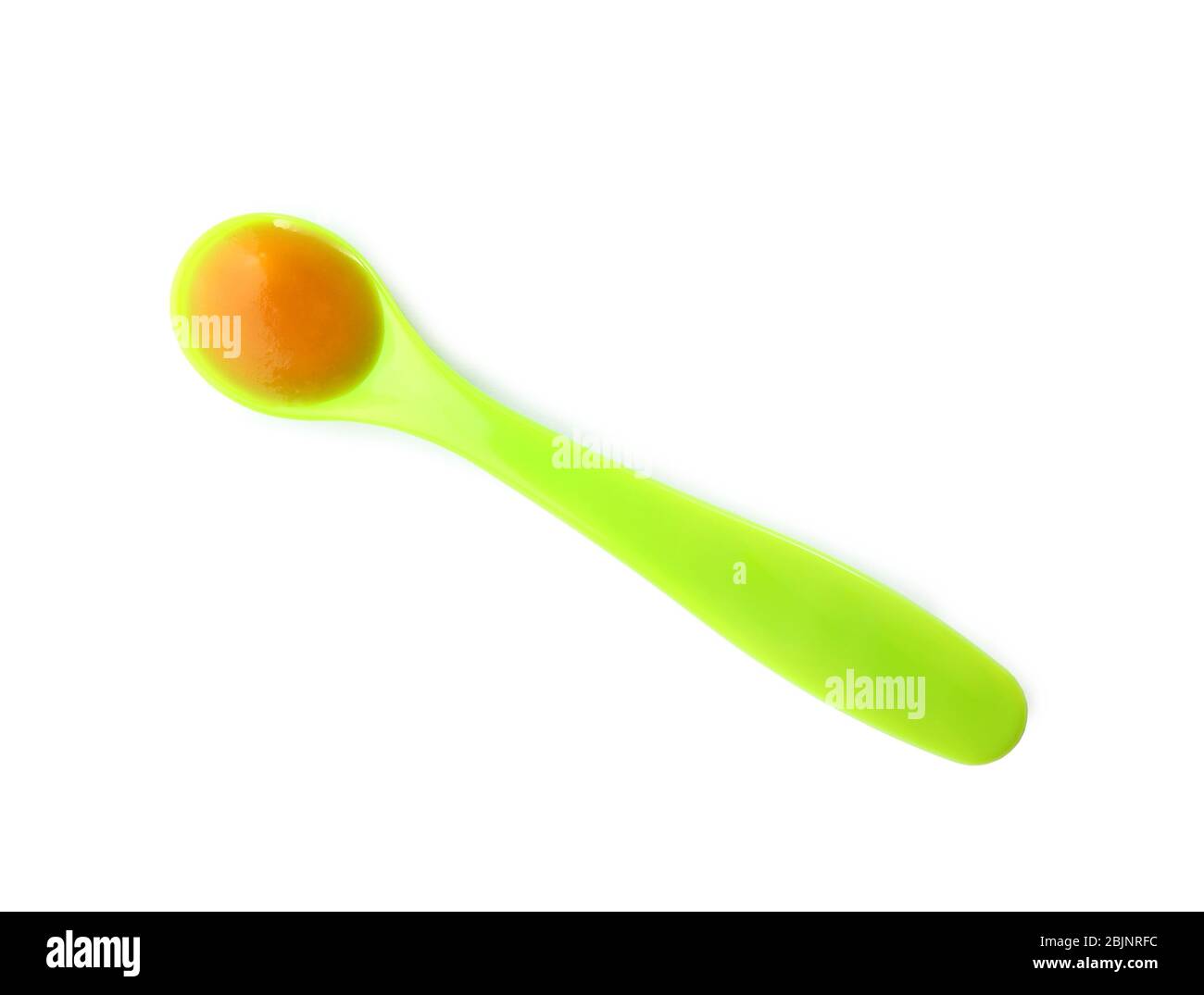 Plastic spoon with baby food on white background Stock Photo - Alamy