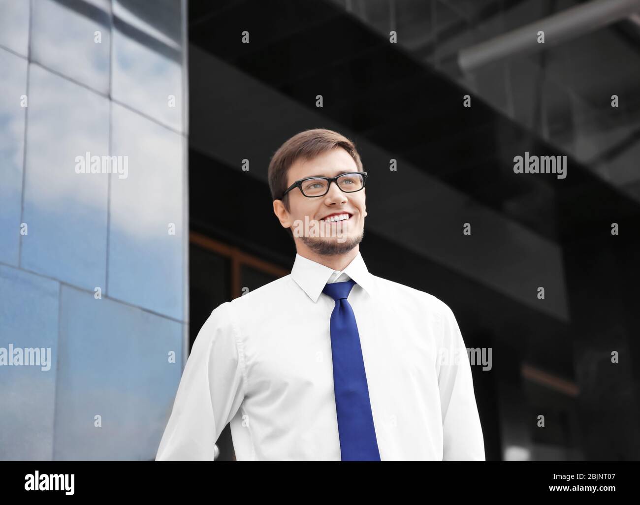 Attractive young man in formal wear on city street Stock Photo - Alamy