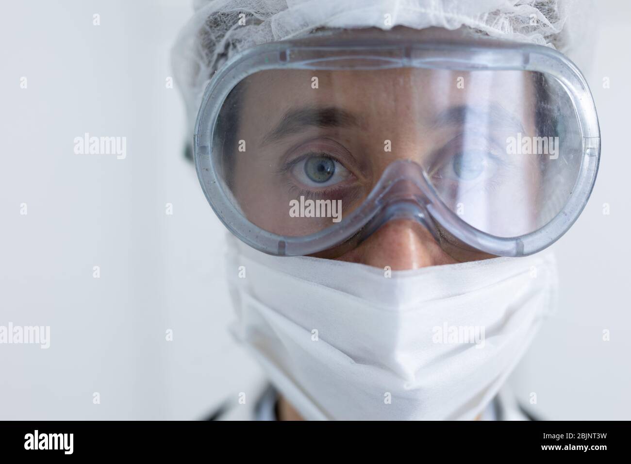 Healthcare worker wearing protective suit and face mask during ...