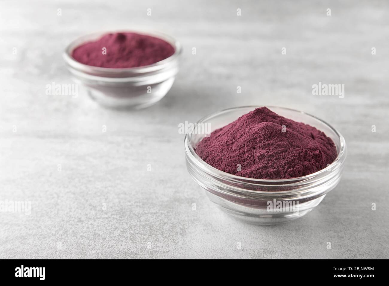 Bowls with acai powder on table Stock Photo - Alamy
