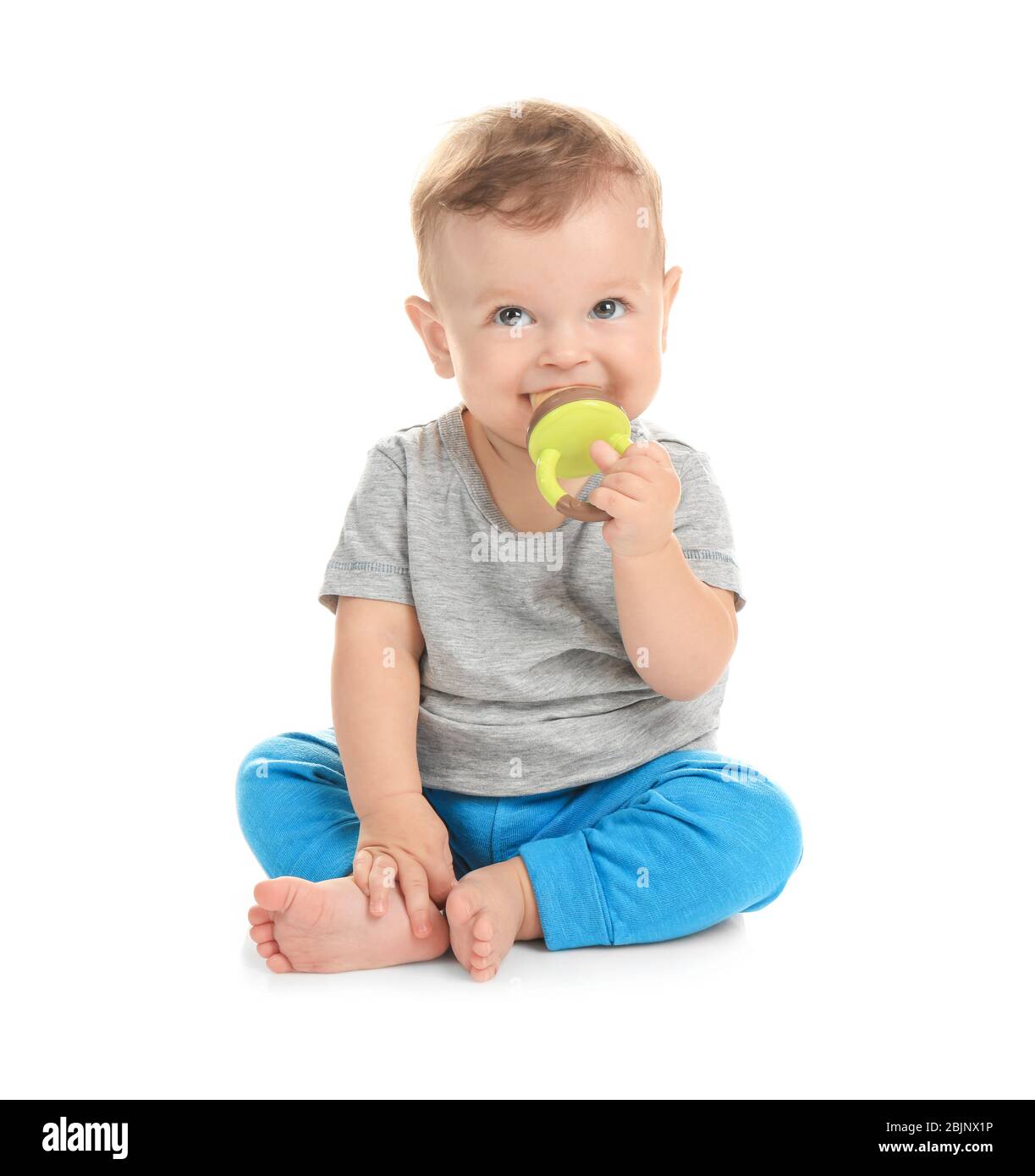 Adorable little baby with nibbler on white background Stock Photo - Alamy