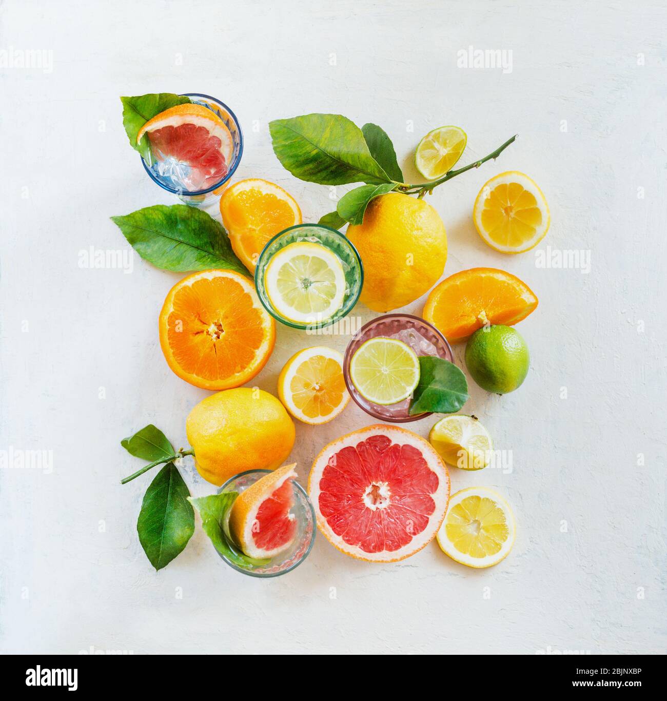 Group composition of various organic citrus fruits with green leaves on ...