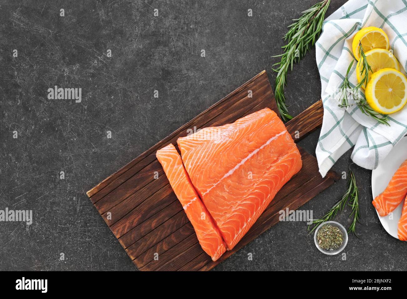 Board with fresh salmon fillet on table Stock Photo - Alamy